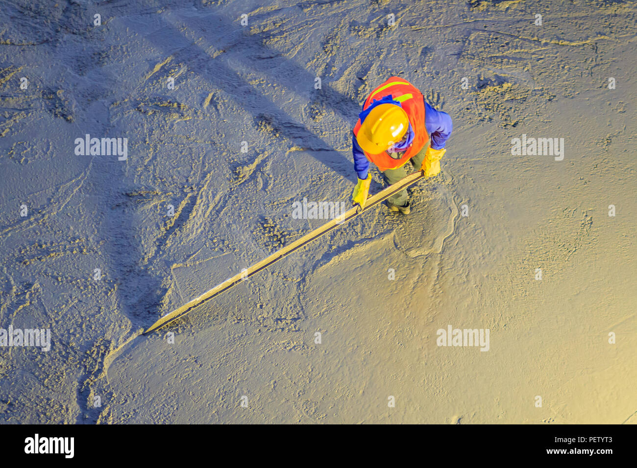 Mason worker leveling concrete with trowels, mason hands spreading ...