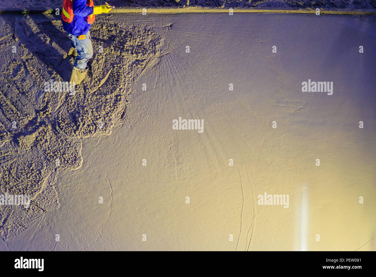 Mason worker leveling concrete with trowels, mason hands spreading ...