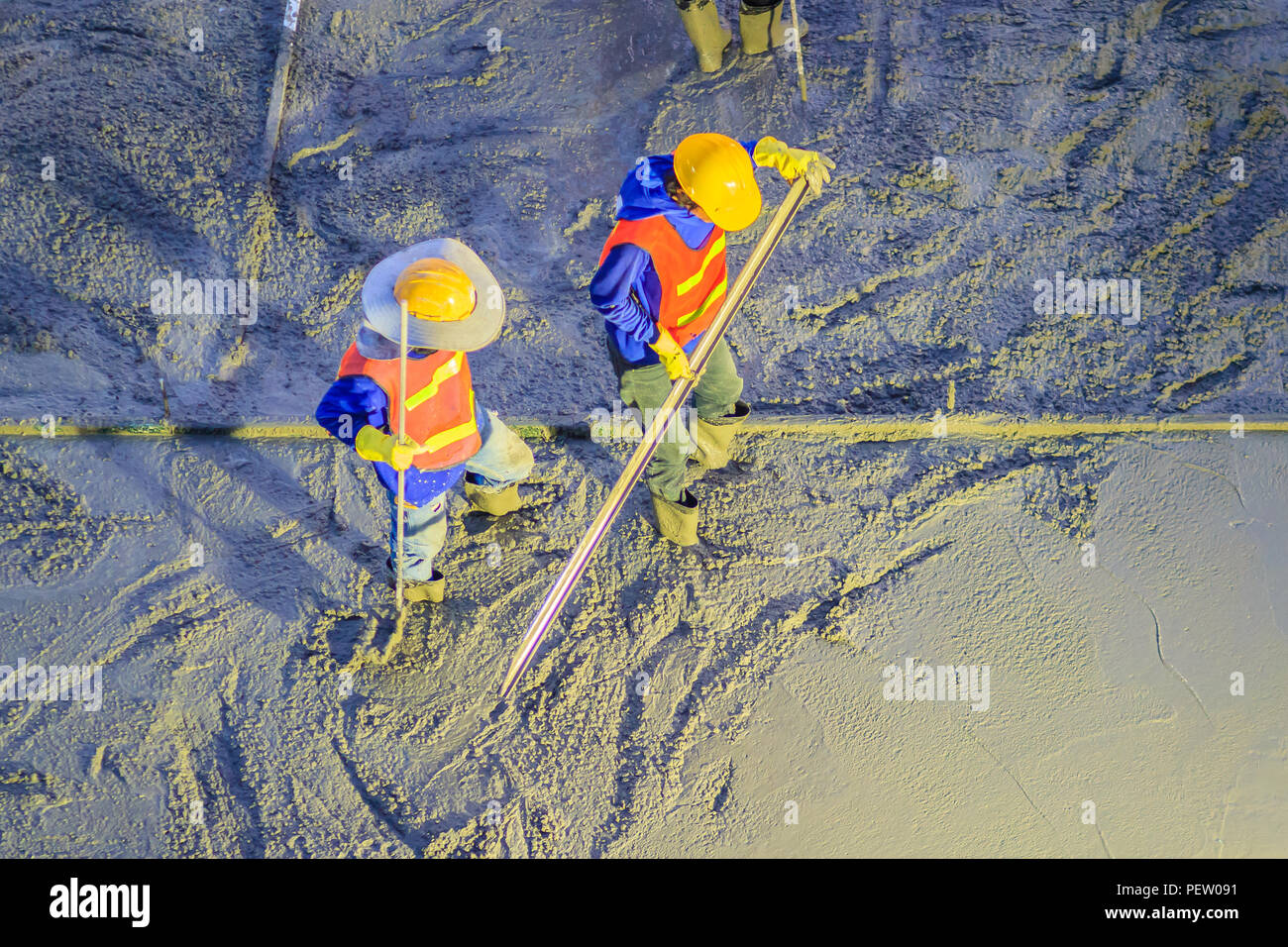 Mason worker leveling concrete with trowels, mason hands spreading ...