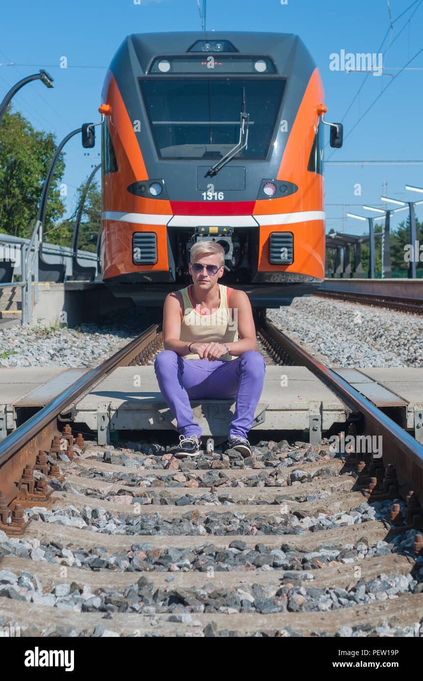 Young trendy guy in front of train Stock Photo - Alamy