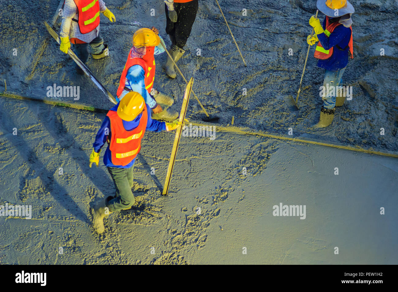 Mason worker leveling concrete with trowels, mason hands spreading ...