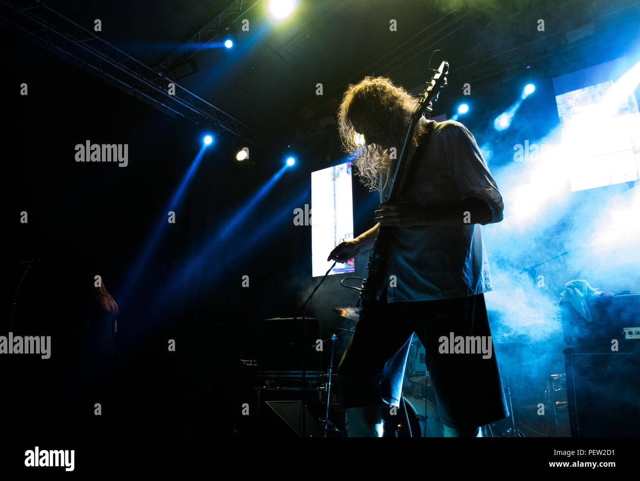 Guitarist on a stage playing rock song Stock Photo - Alamy