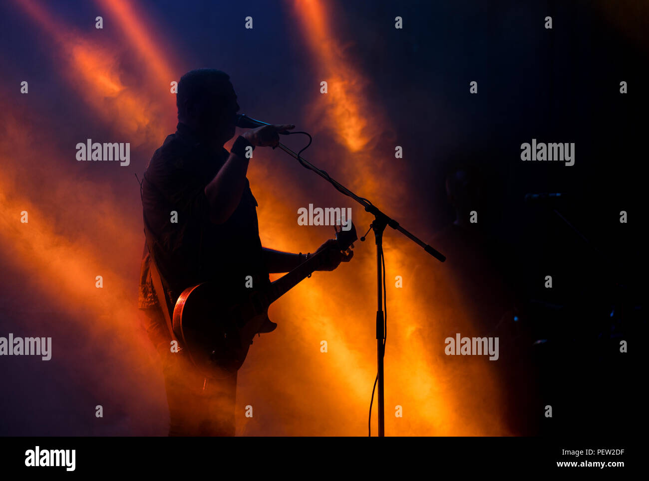 Rock singer on a stage singing rock song Stock Photo - Alamy