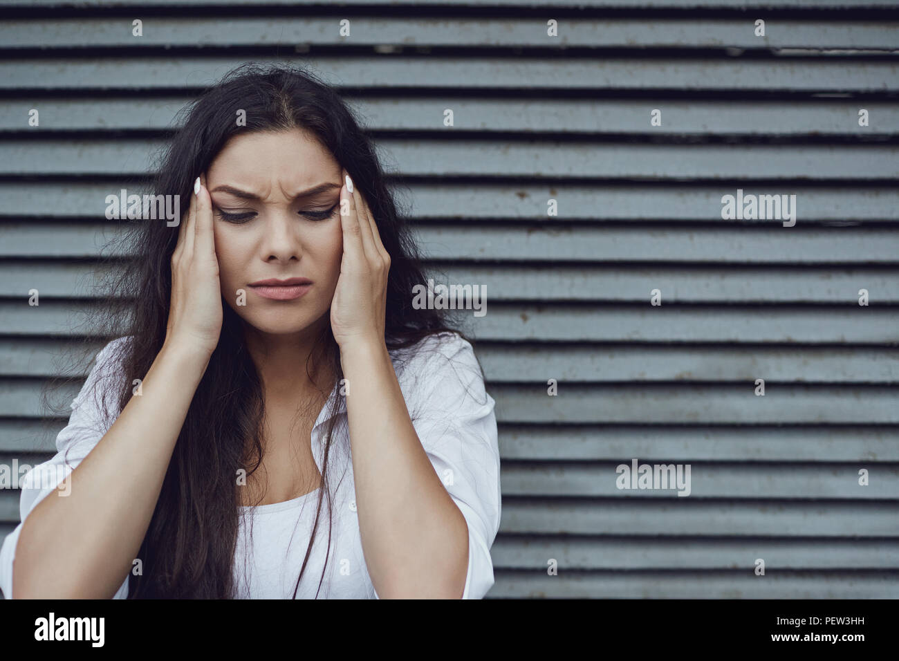 Portrait of a woman with a headache Stock Photo - Alamy