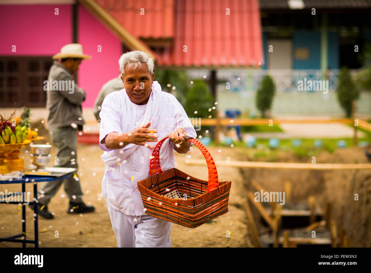 Samai Tanapai Bul tosses flowers during a blessing given at the Wuat ...