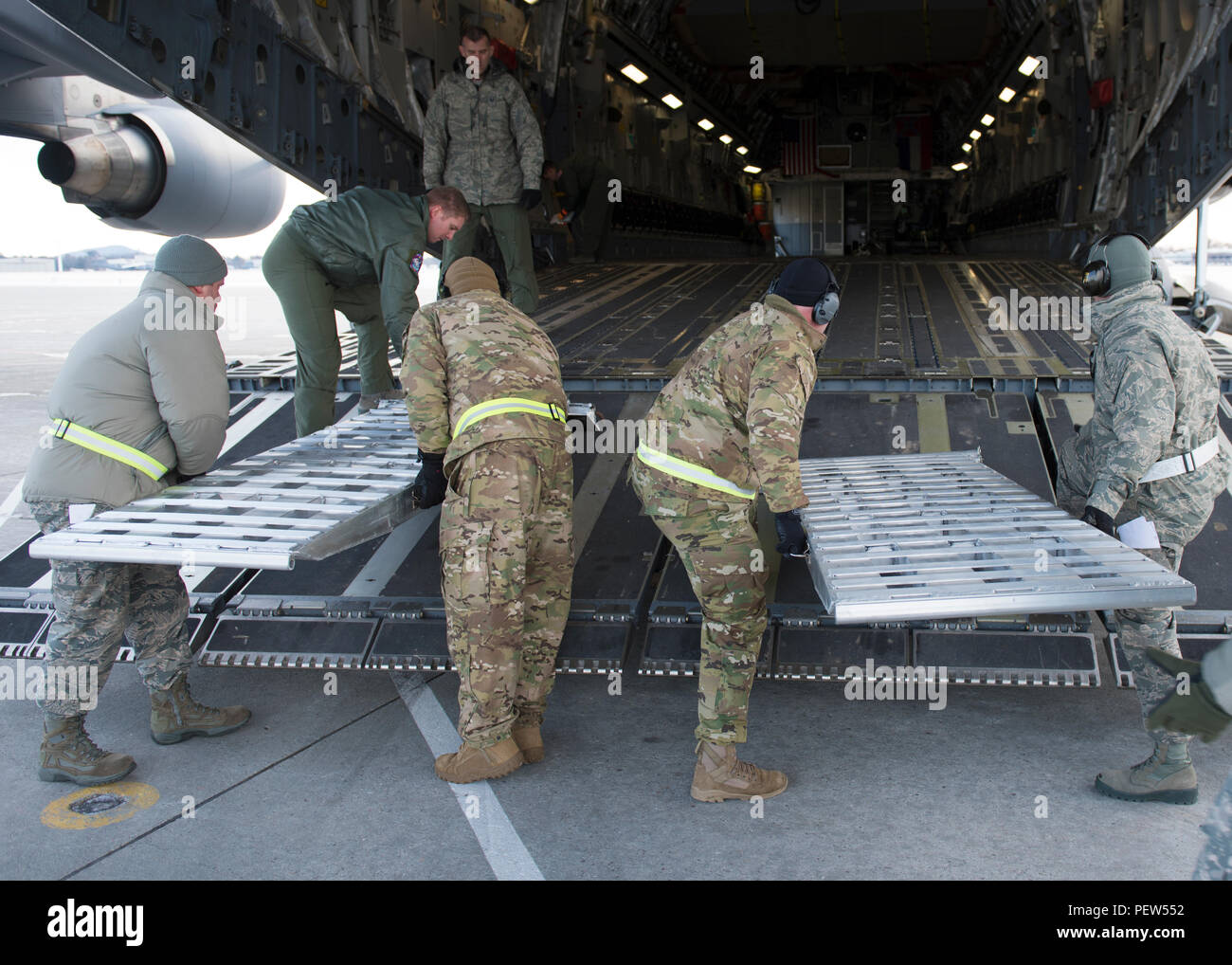 U.S. Army Soldiers and U.S. Air Force Airmen align ramps on a C-17 ...