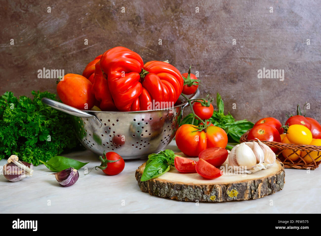 Ripe juicy tomatoes of different varieties, green fragrant basil ...