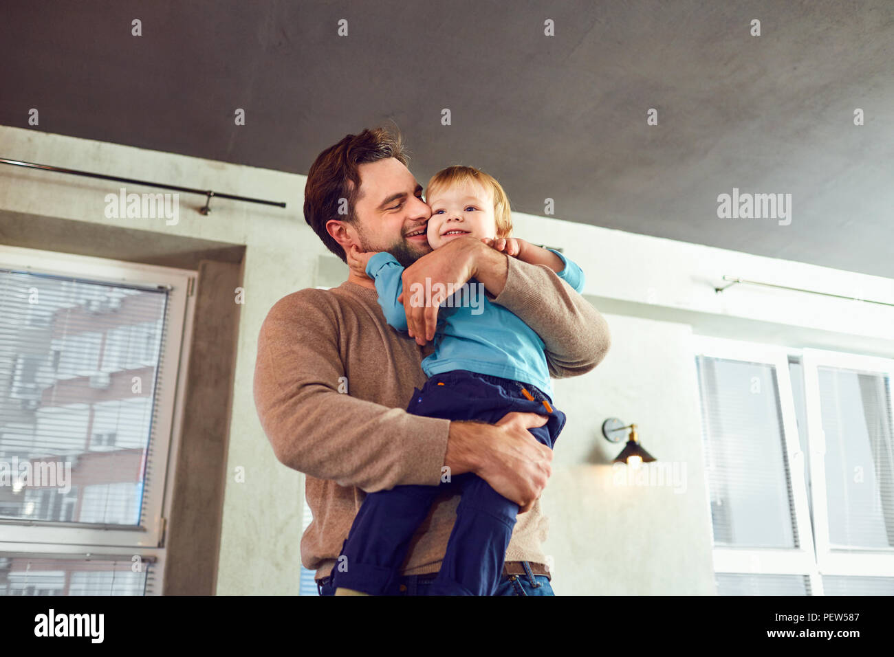 Father and son play hugs in the room Stock Photo - Alamy