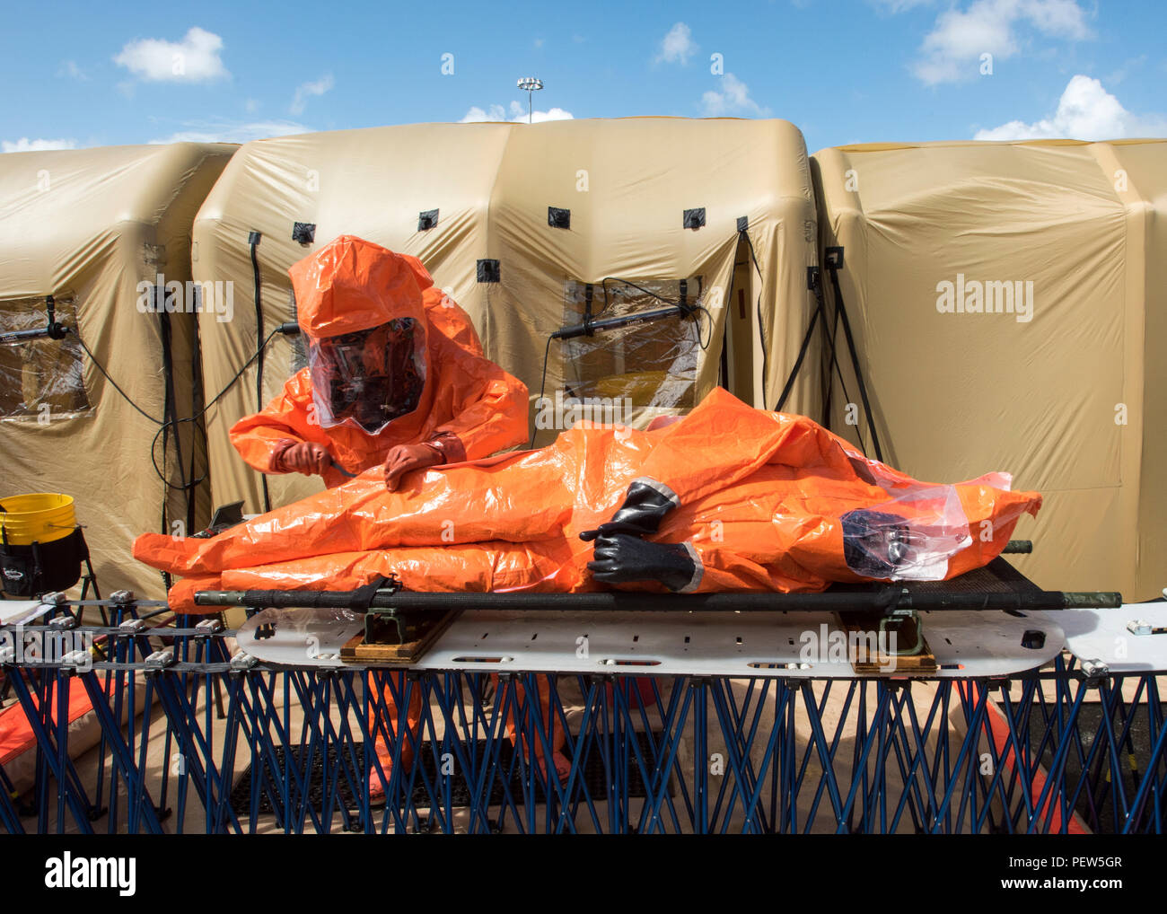 Staff Sgt. Christopher Spear, decon, cuts open U.S. Air Force Tech Sgt ...