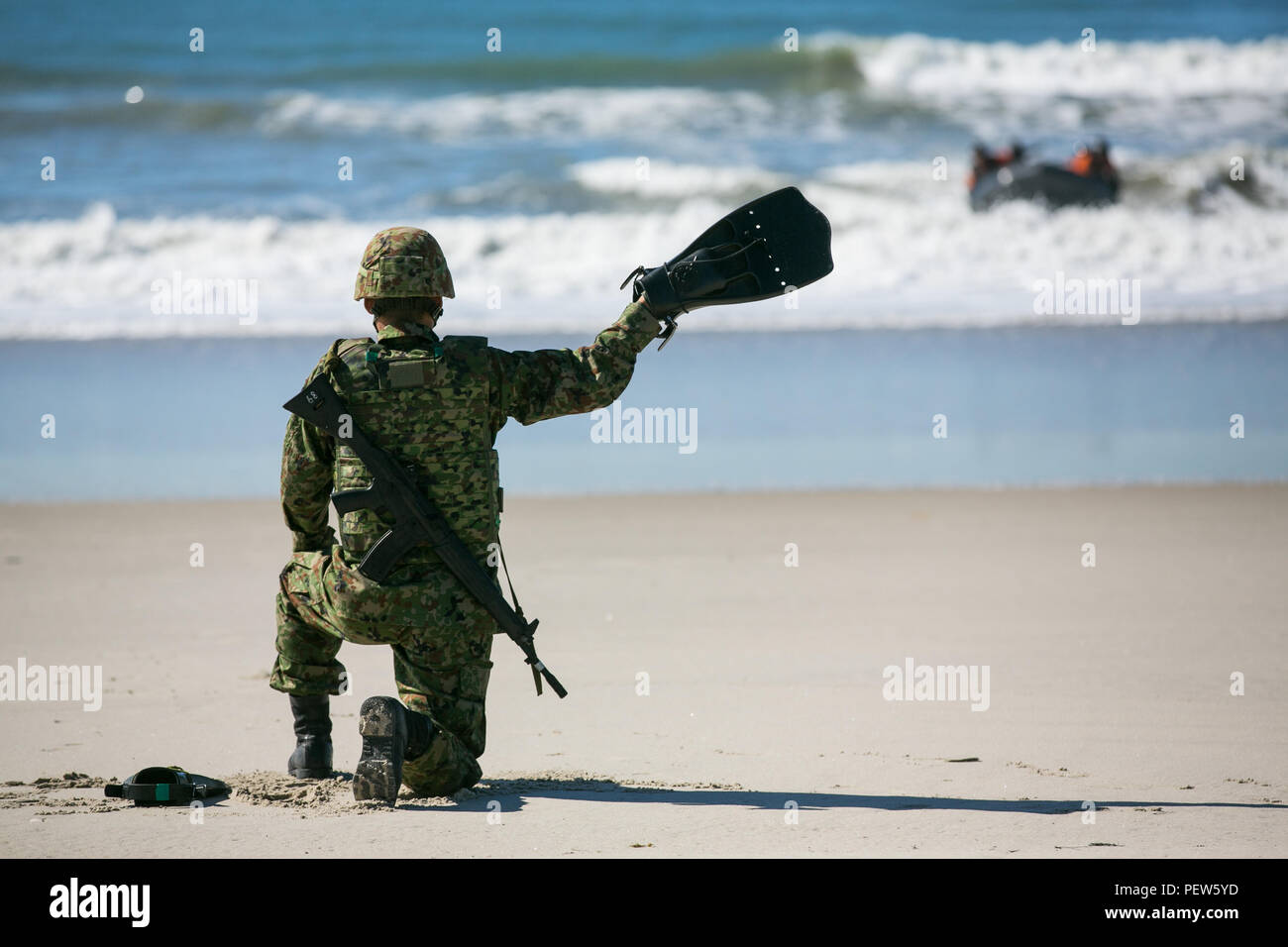 A Japan Ground Self-Defense Force soldier signals a landing location ...
