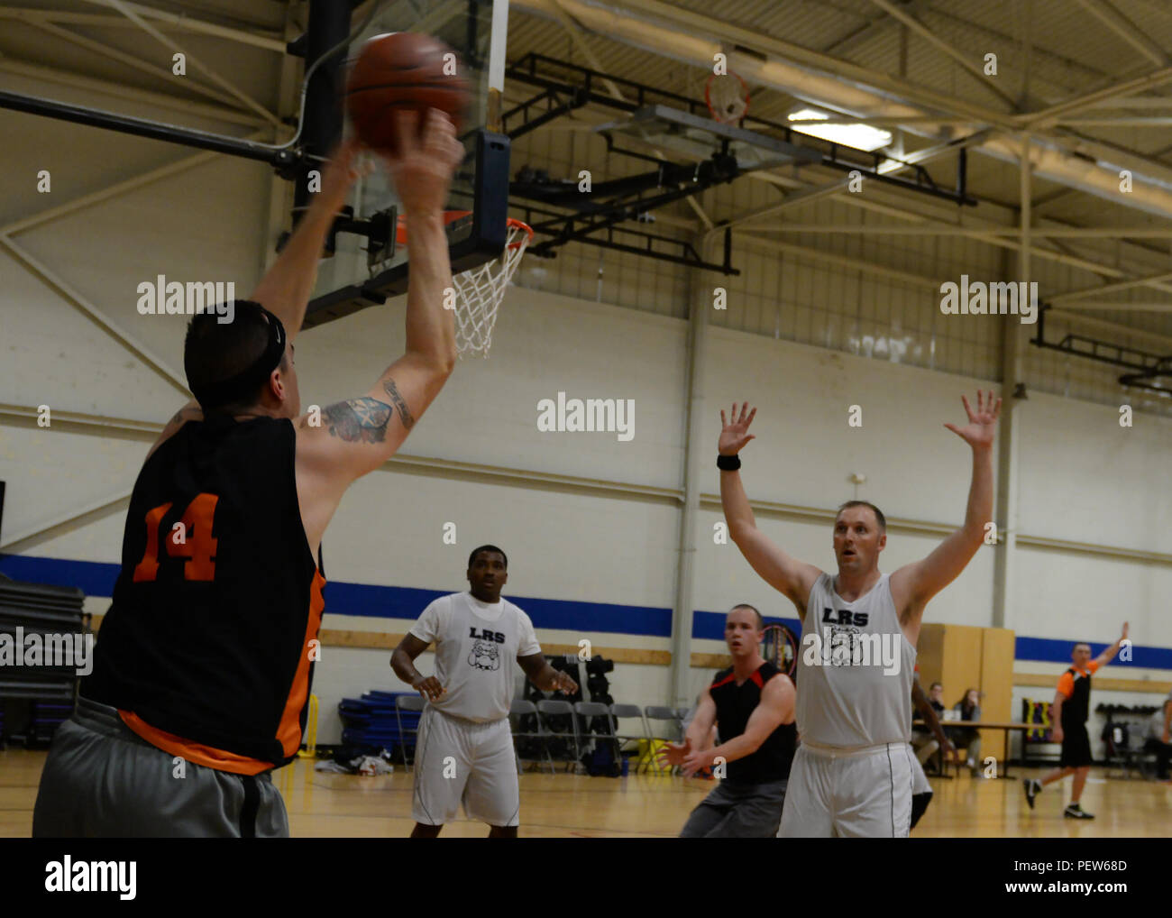 A member of the 97th Operations Support Squadron passes the basketball ...