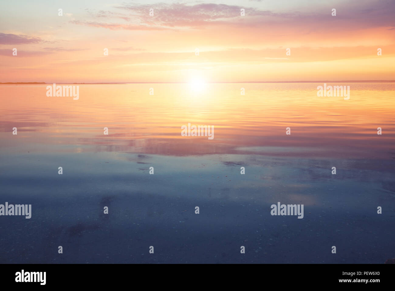 Scenic ocean sunset over the calm water surface Stock Photo - Alamy