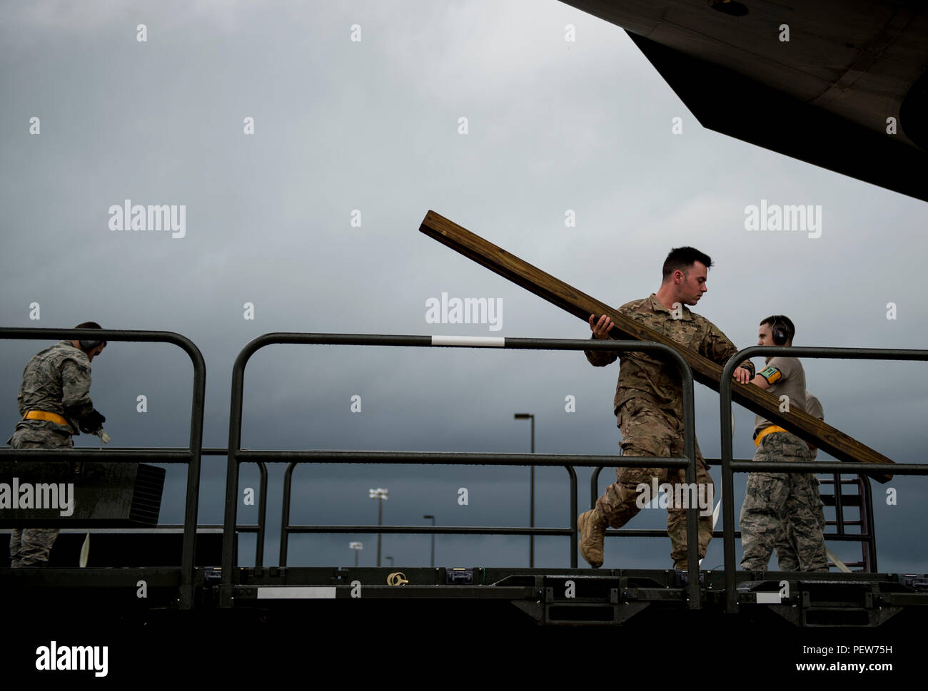 U.S. Air Force Airmen and U.S. Army Soldiers load container delivery ...