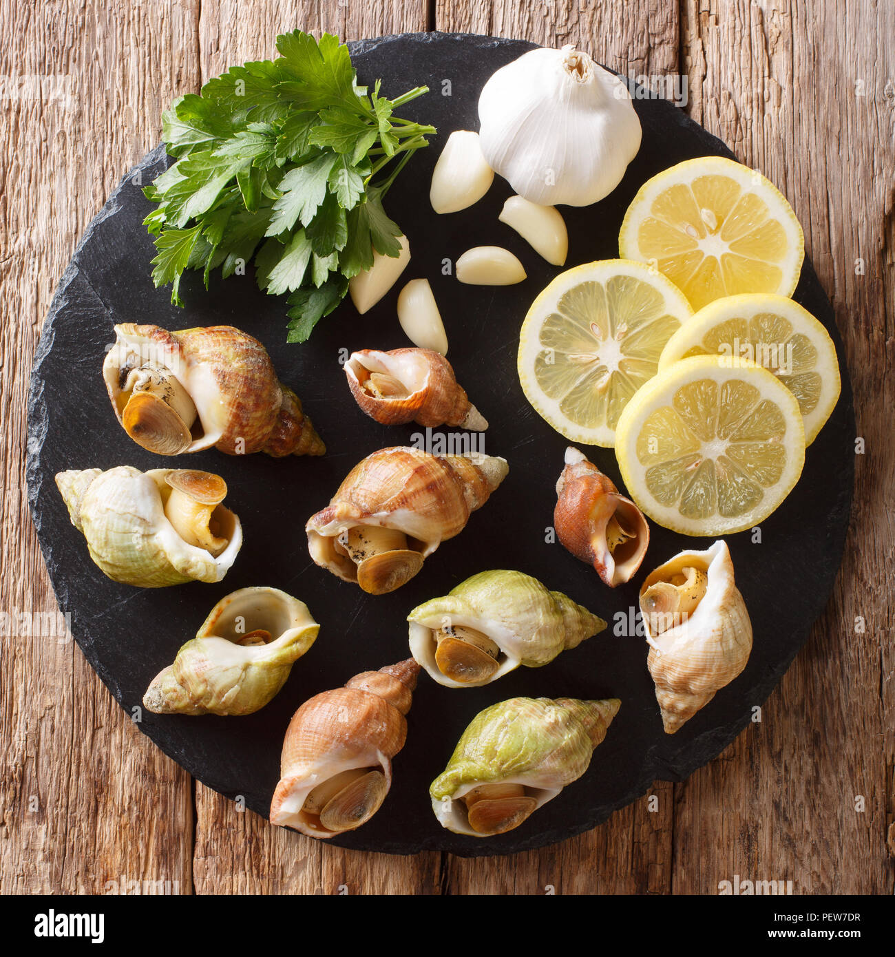 Seafood: raw whelk, sea snails bulot with a garlic and parsley, lemon ...