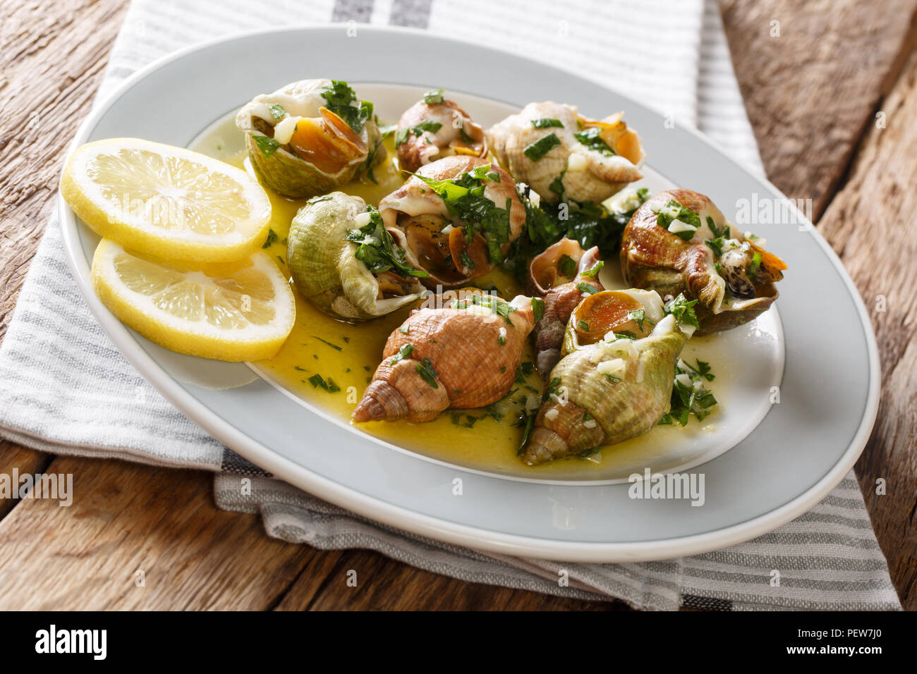 French recipe Whelks with a sauce of butter, garlic and parsley, lemon ...
