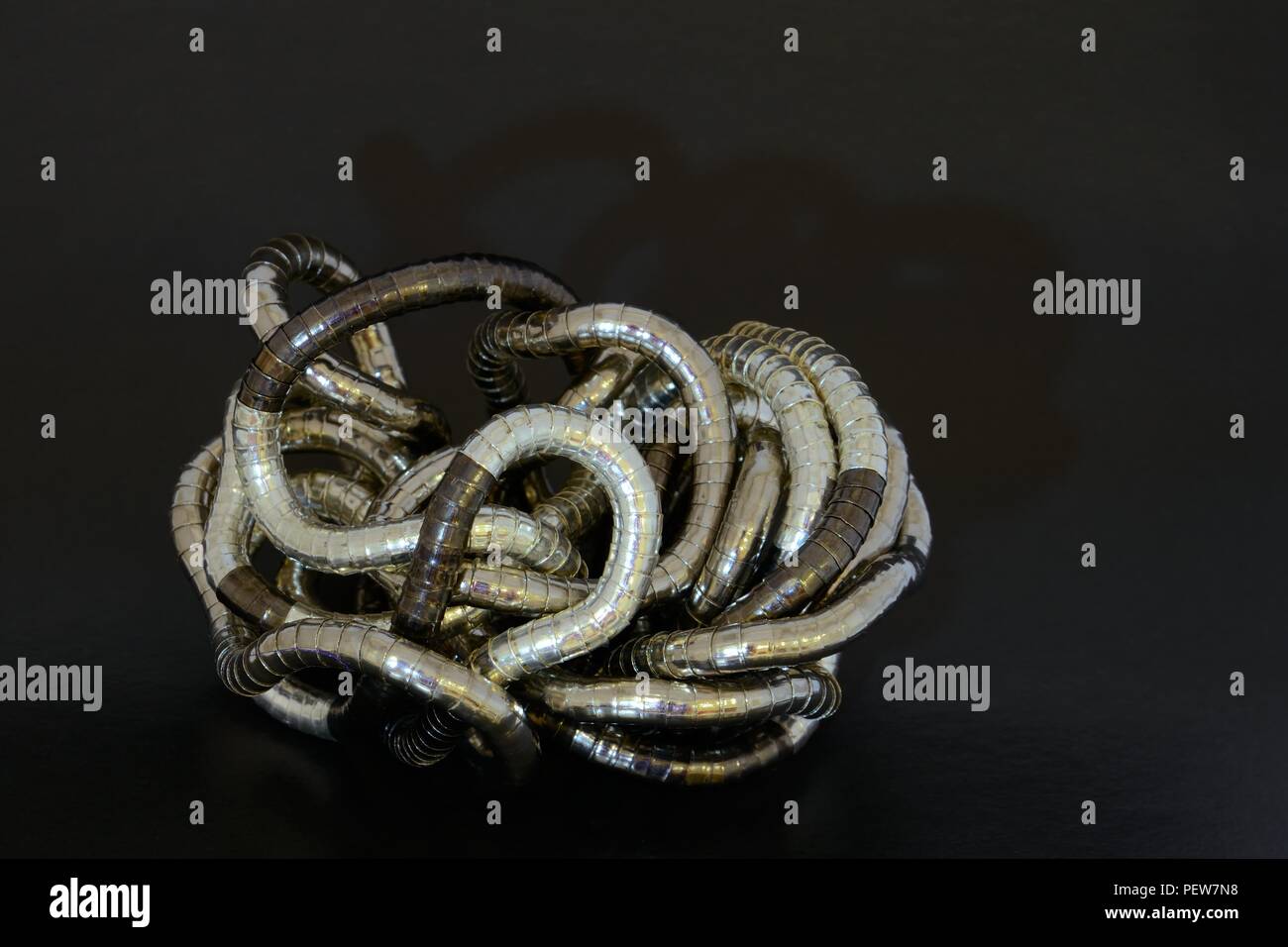 jewelry decoration curled metal on black background Stock Photo - Alamy