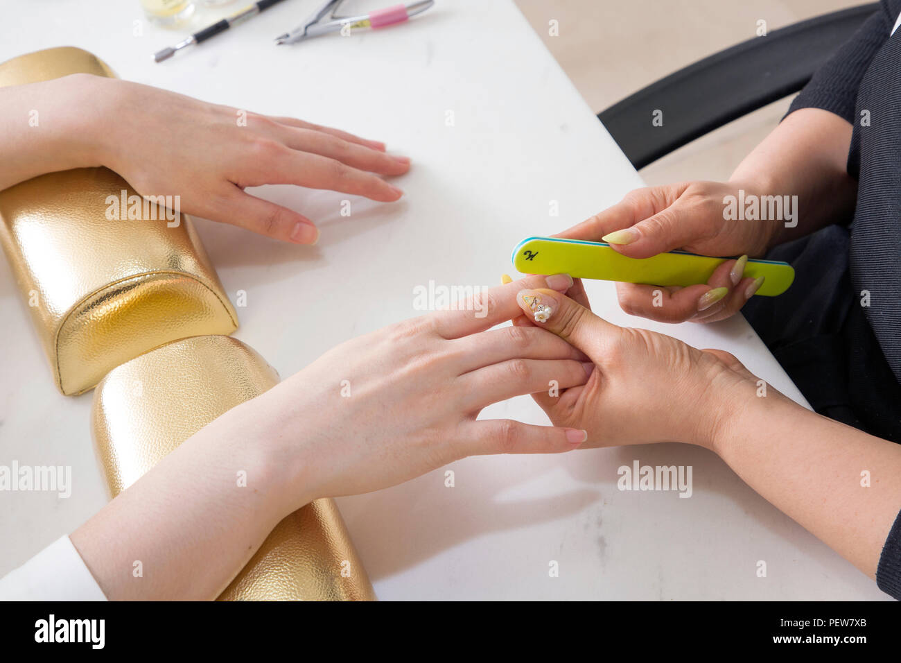 Nail salon woman hands treatment. Nail saloon woman painting color nail ...