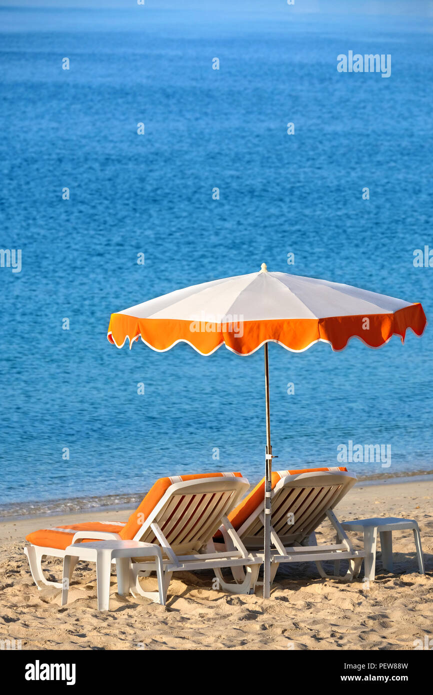 Mediterranean beach with chairs and sun umbrella Stock Photo - Alamy