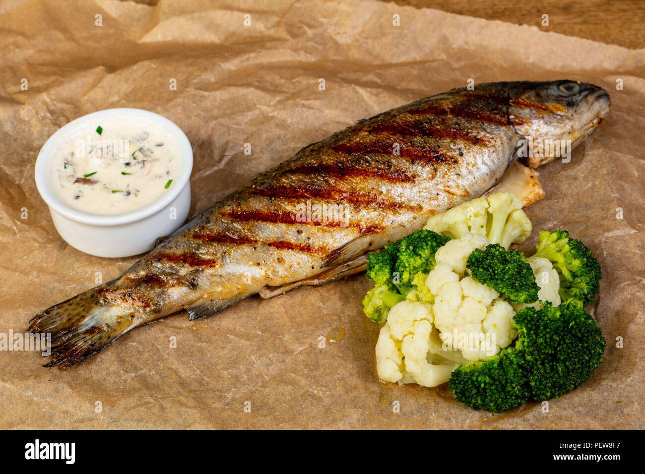 Grilled trout with sauce and broccoli Stock Photo - Alamy