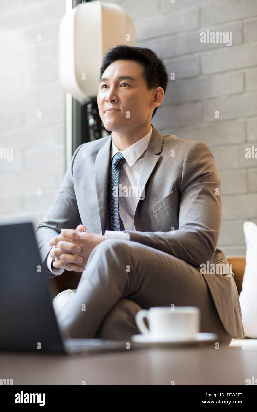 Confident businessman thinking Stock Photo - Alamy