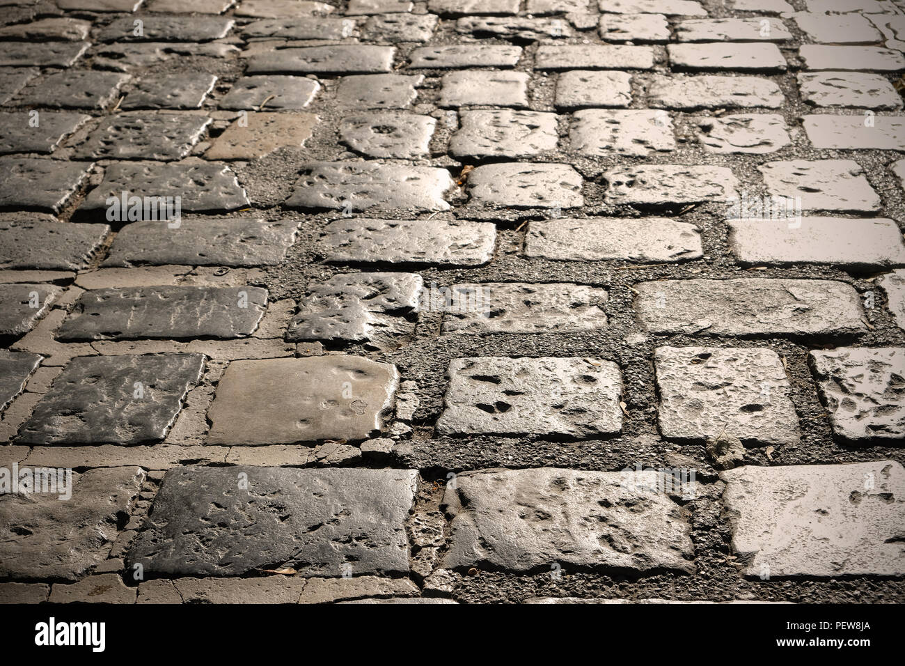 Cobblestone street surface closeup backlit Stock Photo - Alamy