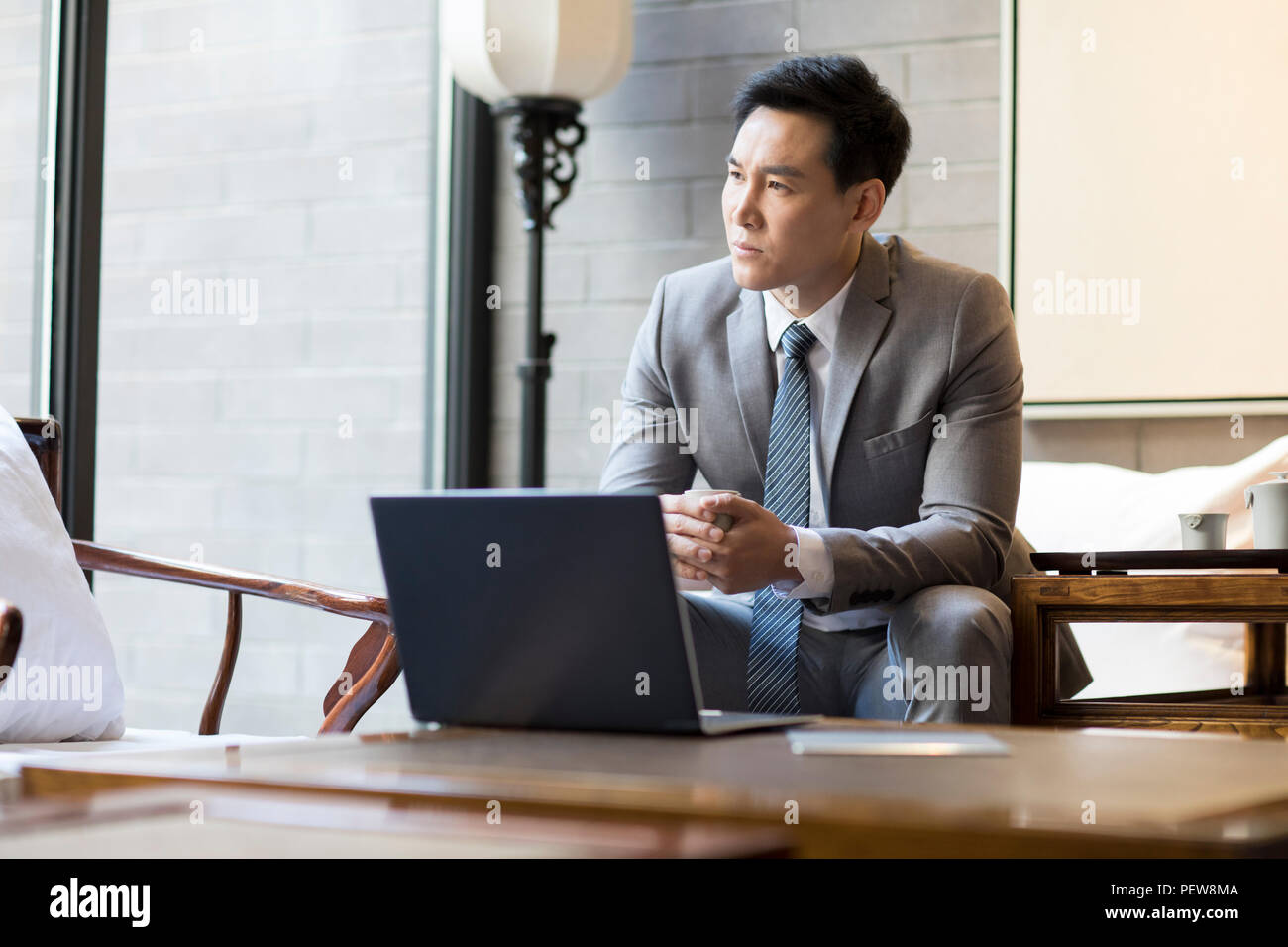 Confident businessman thinking Stock Photo - Alamy