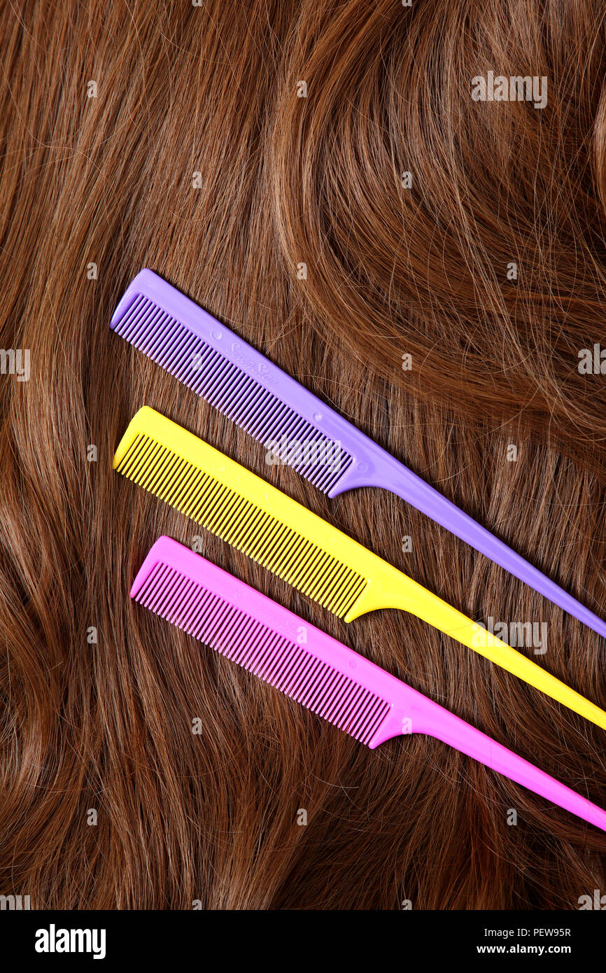 Long colorful hair with objects related to hair salon on close up ...