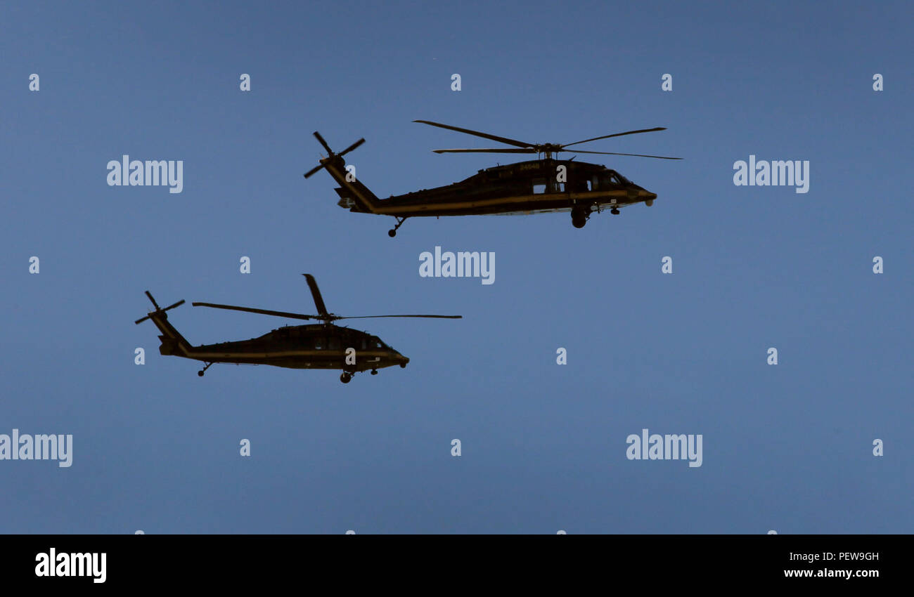 Two U.S. Customs and Border Protection Black Hawk helicopters fly near ...