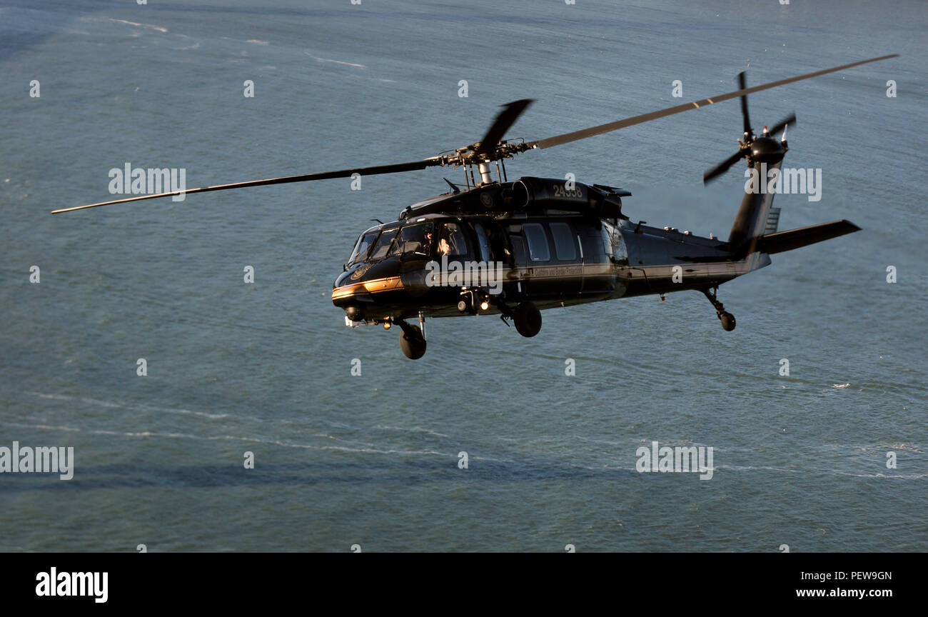A U.S. Customs and Border Protection Black Hawk helicopter flies near ...