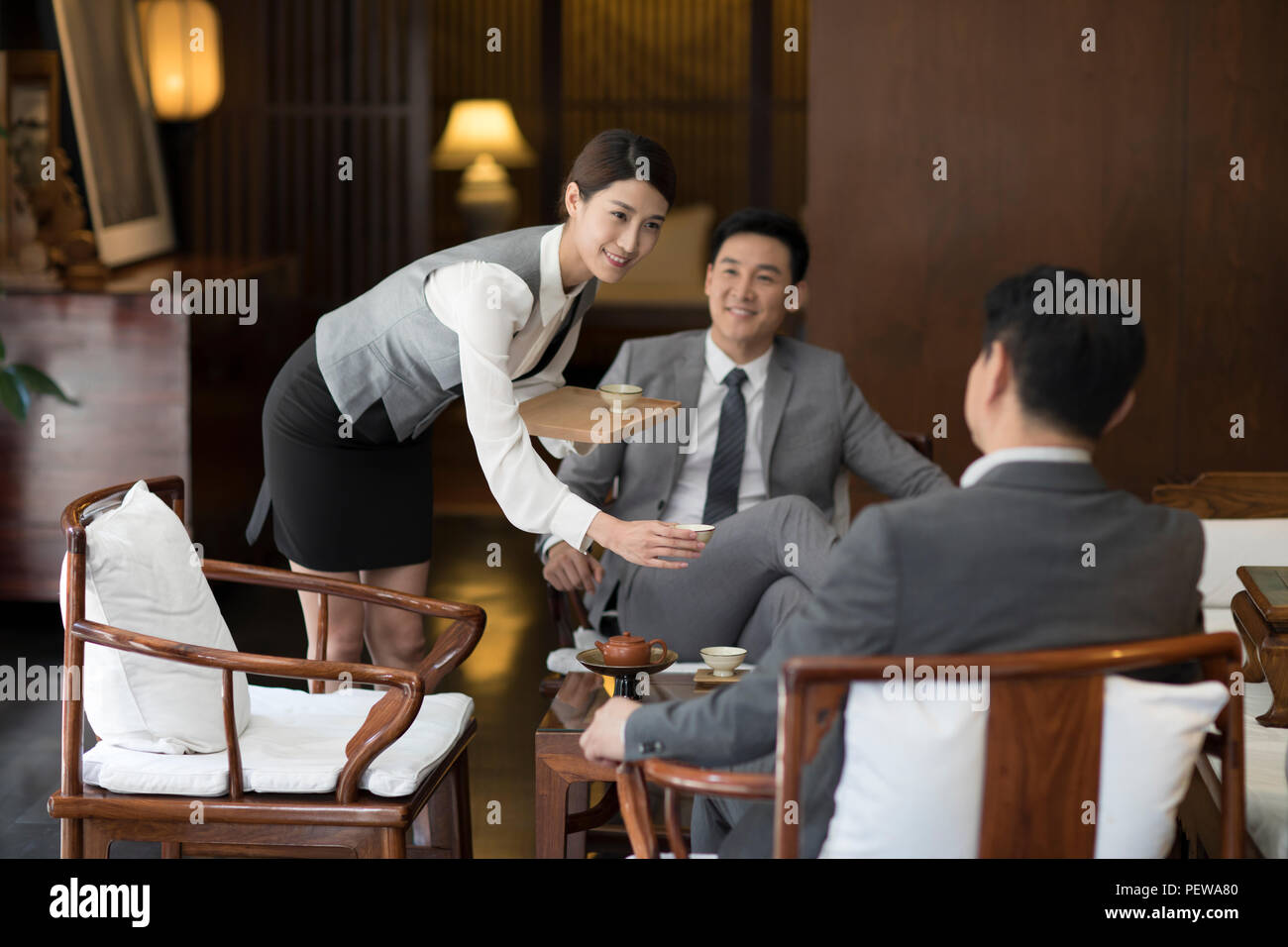 Cheerful businessmen talking in tea room Stock Photo - Alamy