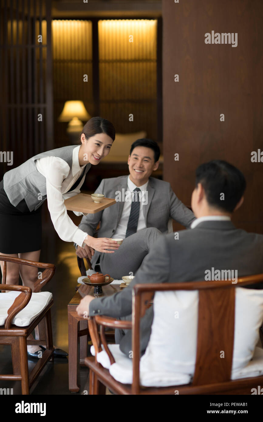Cheerful businessmen talking in tea room Stock Photo - Alamy