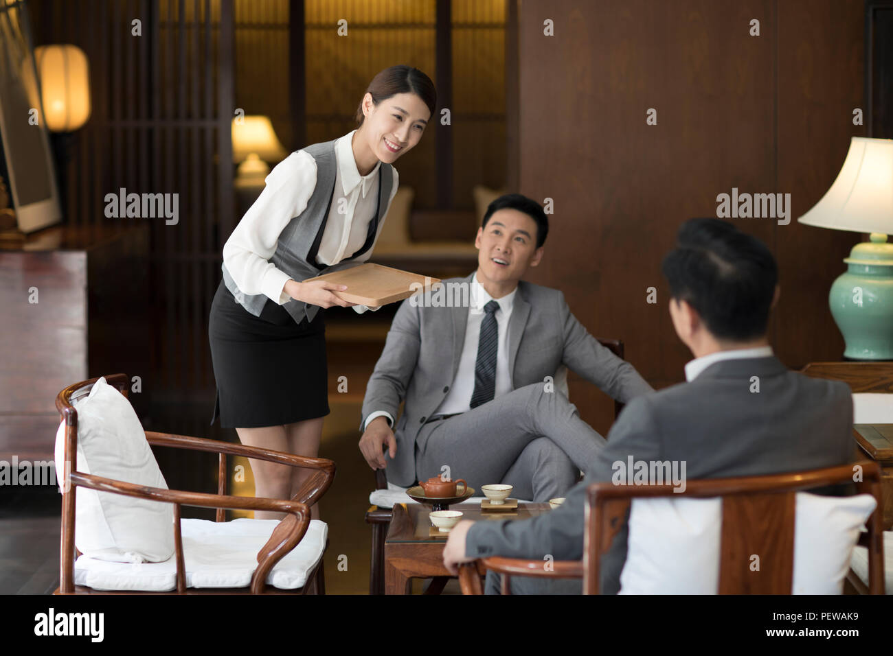 Cheerful businessmen talking in tea room Stock Photo - Alamy