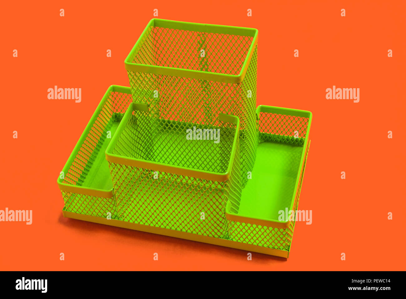 green empty pencil holder on an orange surface Stock Photo - Alamy