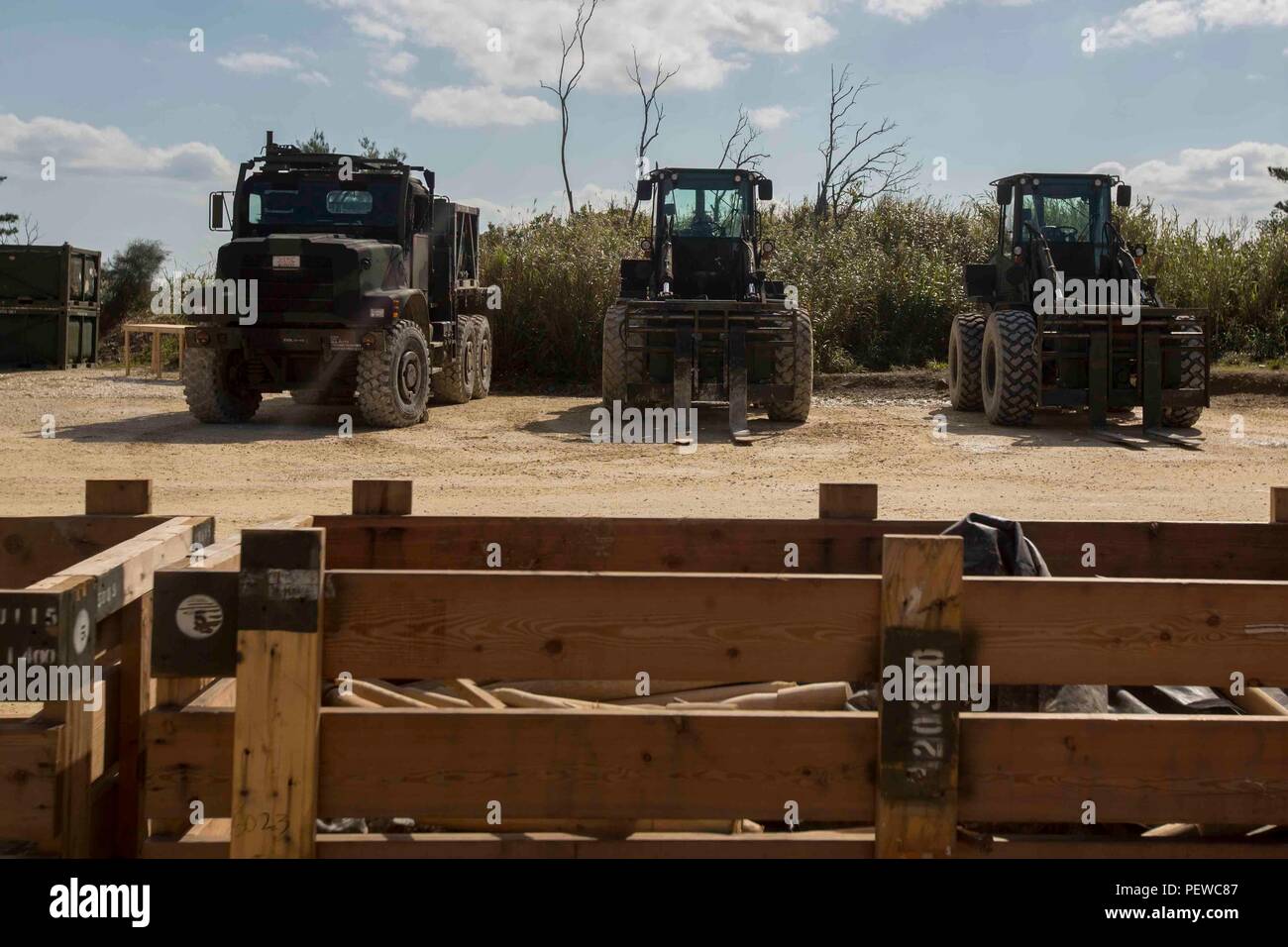 A heavy armored vehicle, and two Tractor, Rubber Tired, Articulated ...