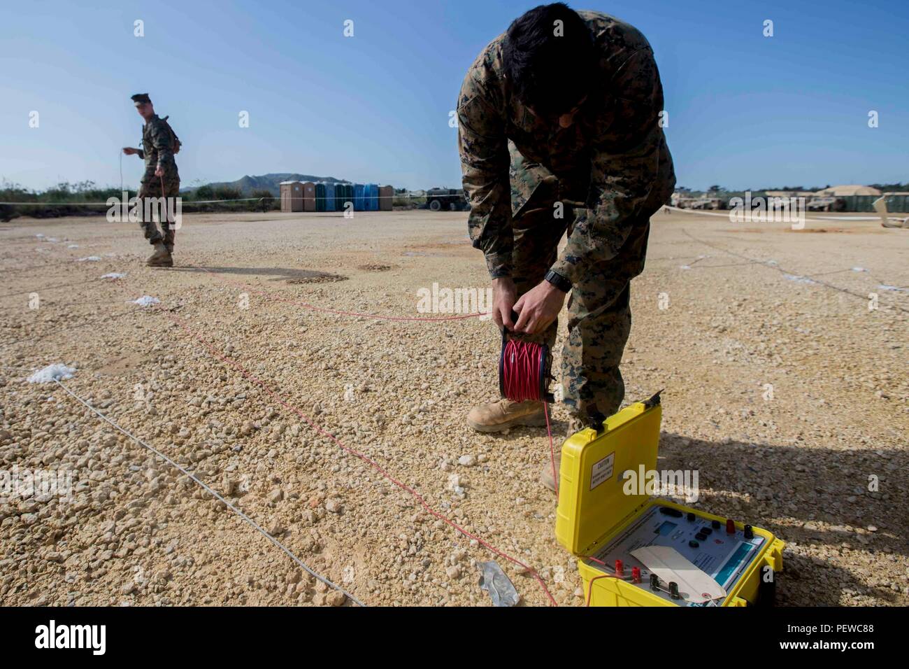 U.S. Marines with 7th Communication Battalion use a wire to measure ...