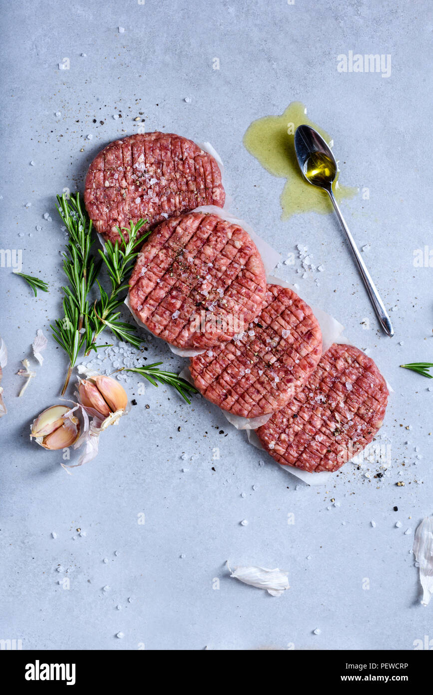 Raw burger cutlets, ground beef meat with spices, hamburger ingredients ...
