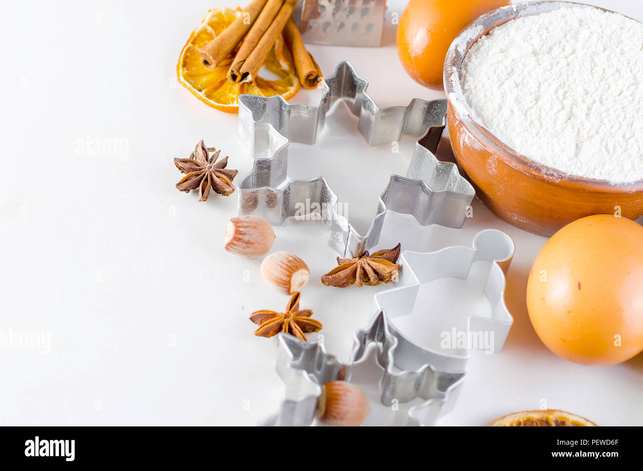 Ingredients for Christmas baking including eggs, flour in bowl, sieve ...