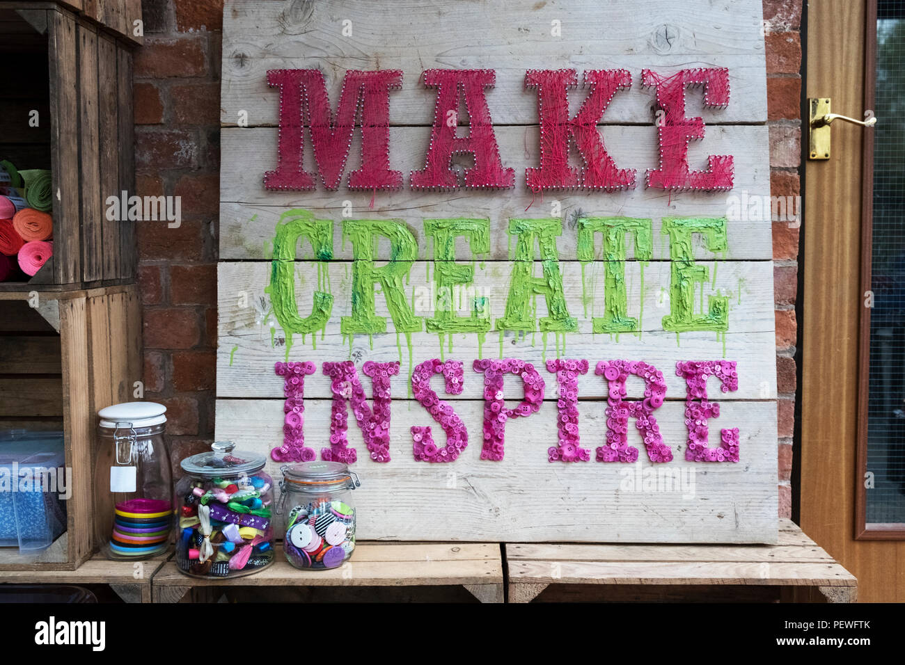 Handmade wooden sign with fabric letters in a workshop Stock Photo - Alamy