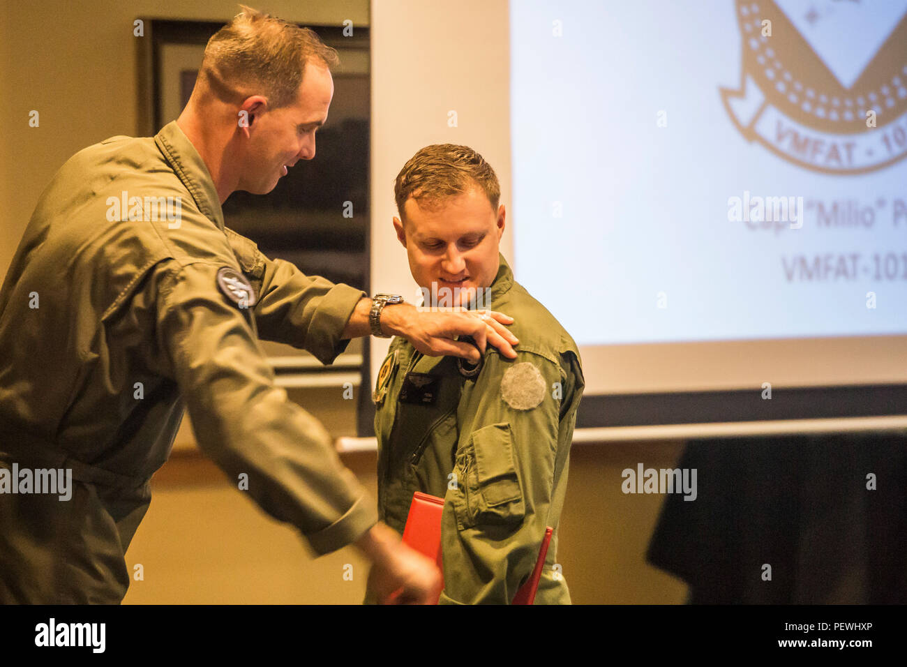 Col. Robert Cooper, left, removes a patch from Capt. Colin P. Pena's ...