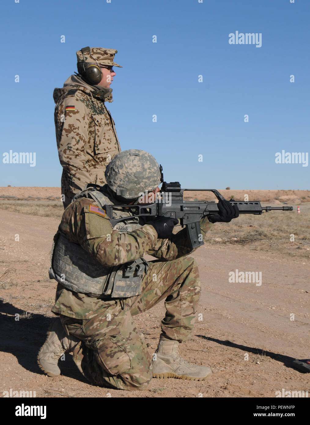 German Air Force Master Sgt. Stephan Plambeck watches as Spc. Kenneth ...