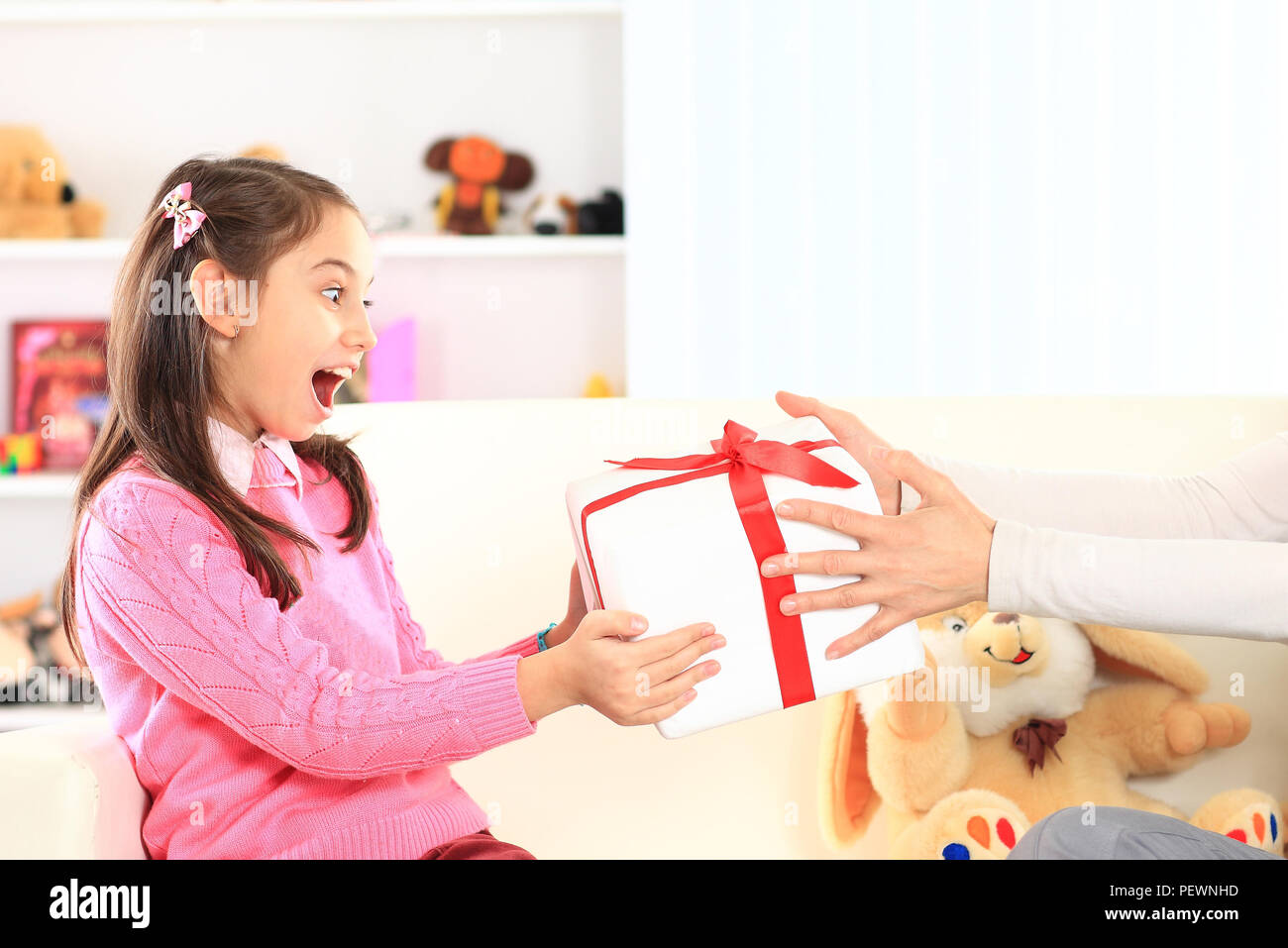 Little beautiful pretty girl giving a gift to her happy mother Stock ...