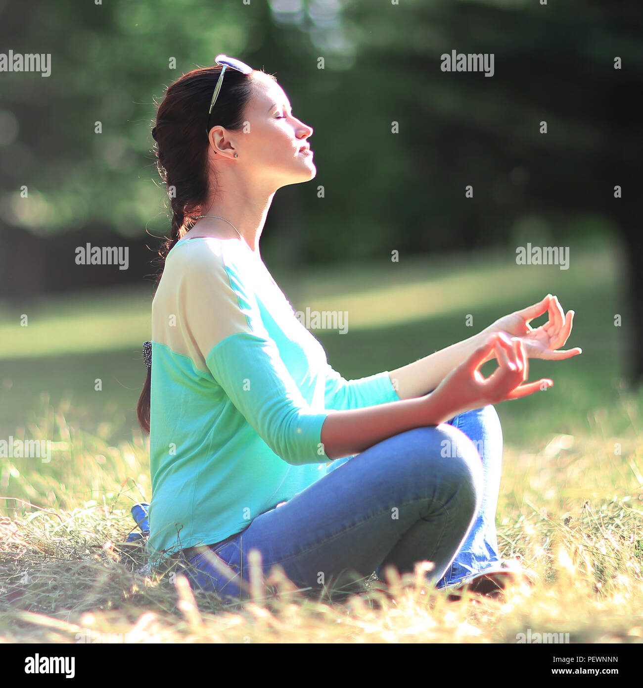 Attractive young woman in a lotus position Stock Photo - Alamy