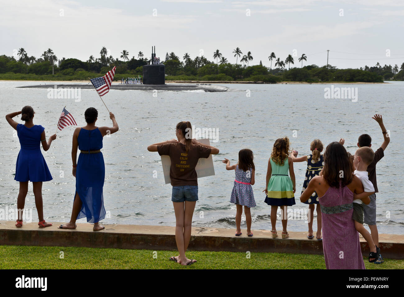 Family members and friends gather at Pearl Harbor to welcome the crew ...