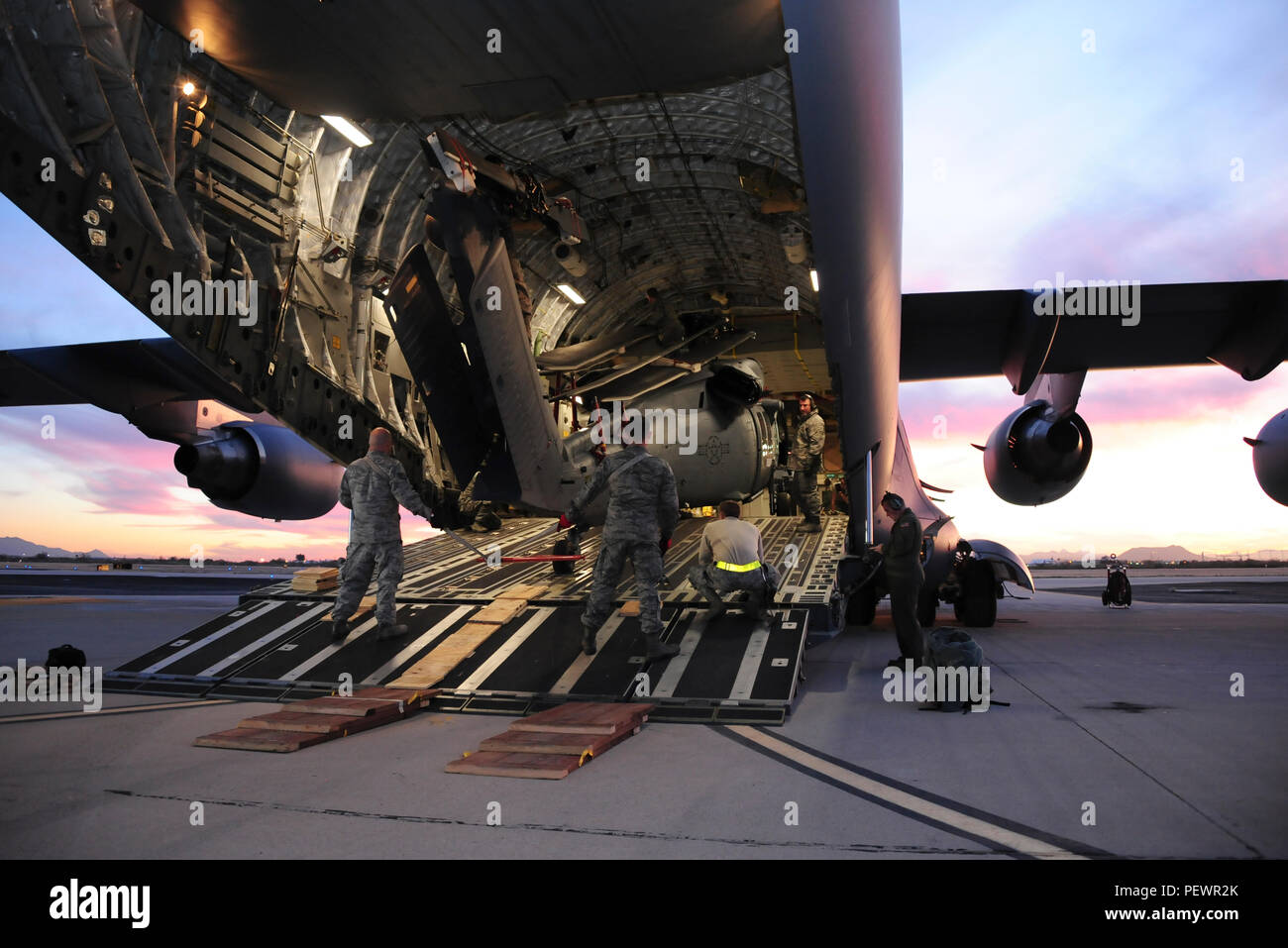 Airmen off-load an HH-60 from a C-17 at Davis-Monthan Air Force Base ...