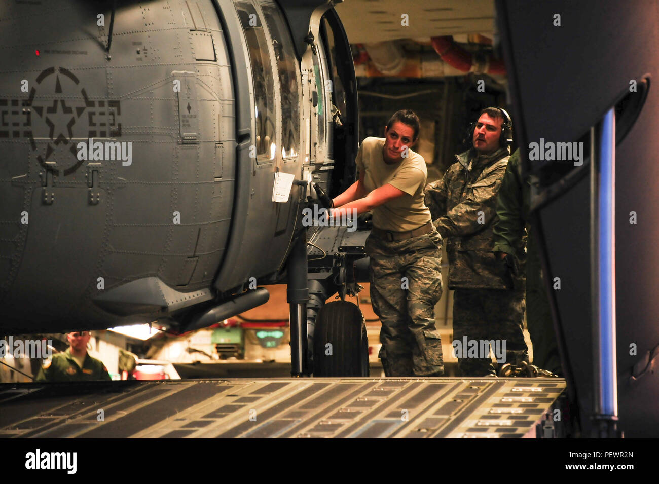 Airmen off-load an HH-60 from a C-17 at Davis-Monthan Air Force Base ...