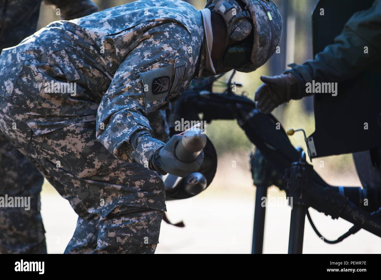 A rocket is loaded into an OH-58 Kiowa Warrior during the unit's aerial ...