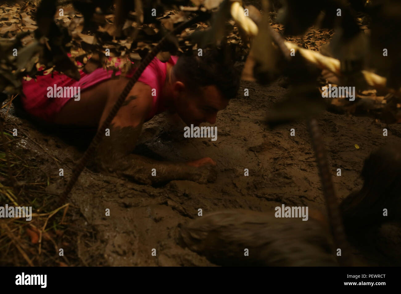 A racer was low crawling in mud underneath camouflage netting as one of ...