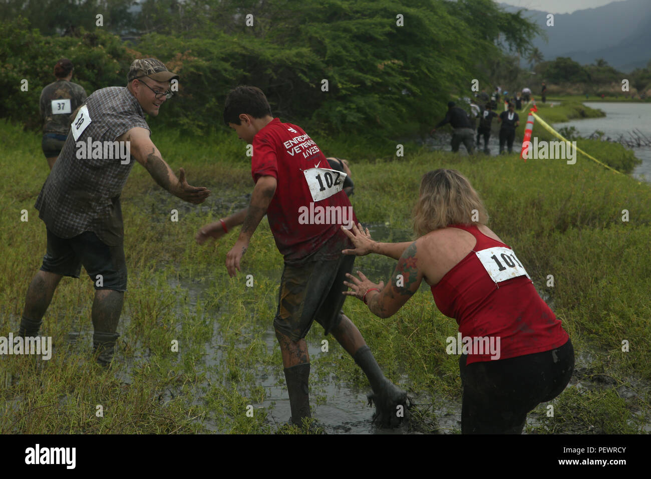 Participants of the Swamp Romp worked together to get across the mud ...