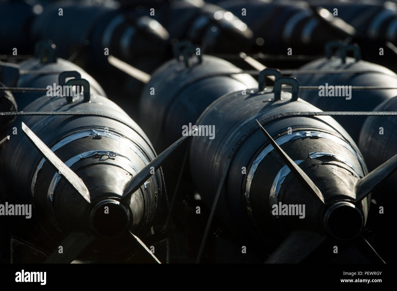 Bomb Drop Unit-50 training explosives are lined up on a transport ...
