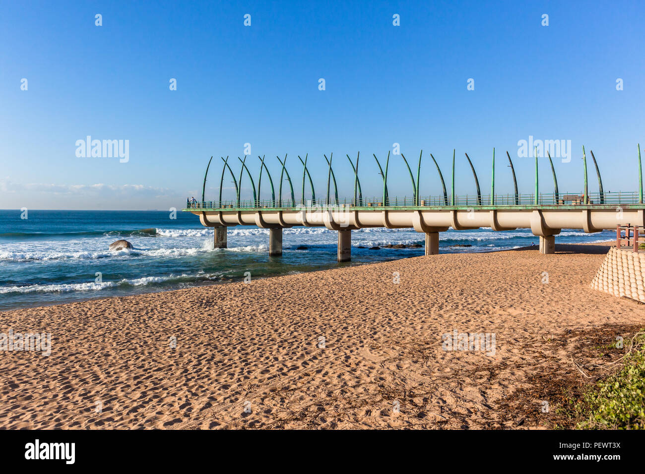 Beach pier jetty structure with elephant tusks design into blue ocean ...